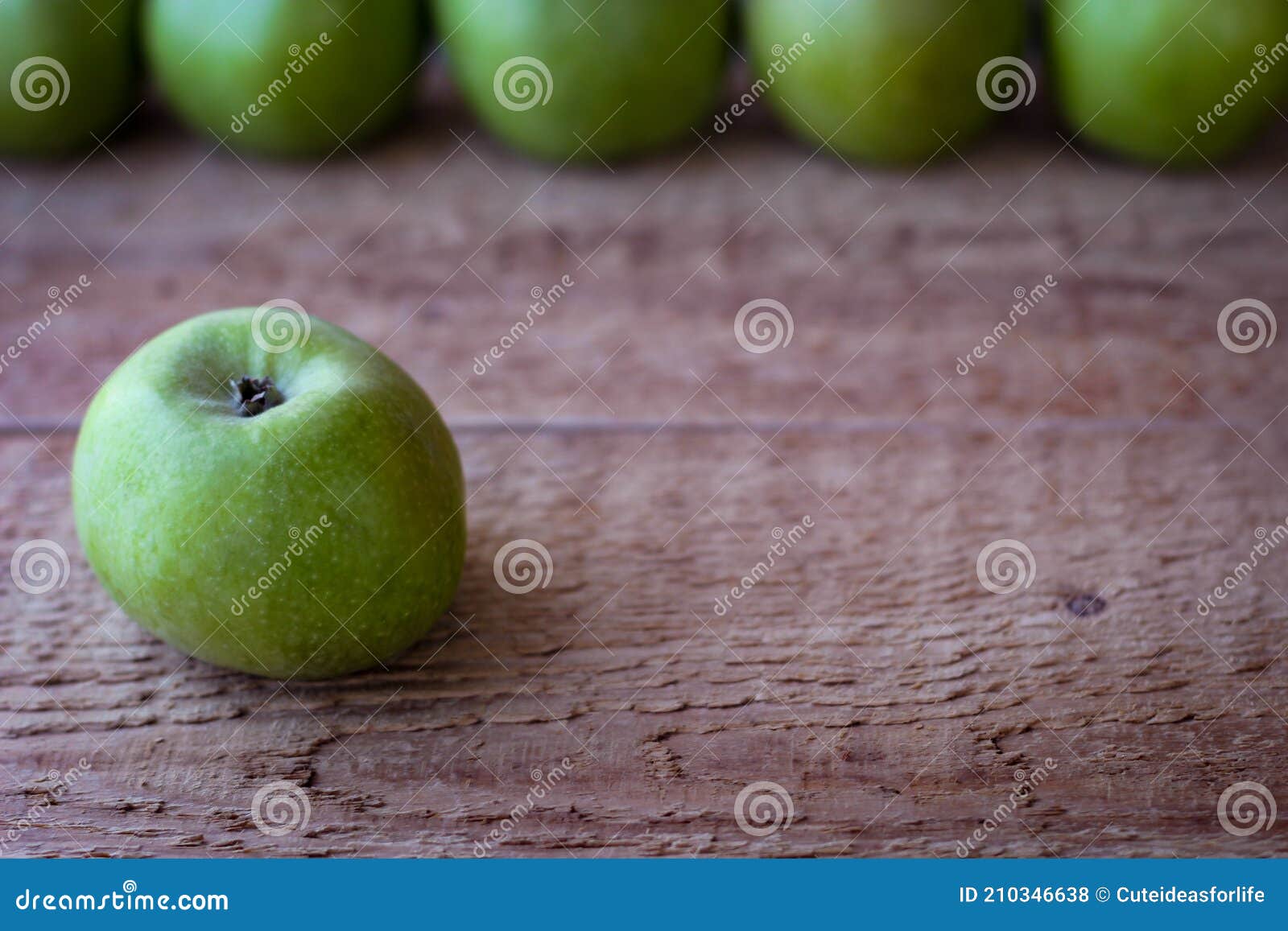 Green Apples Stand on a Wooden Surface Stock Photo - Image of ...