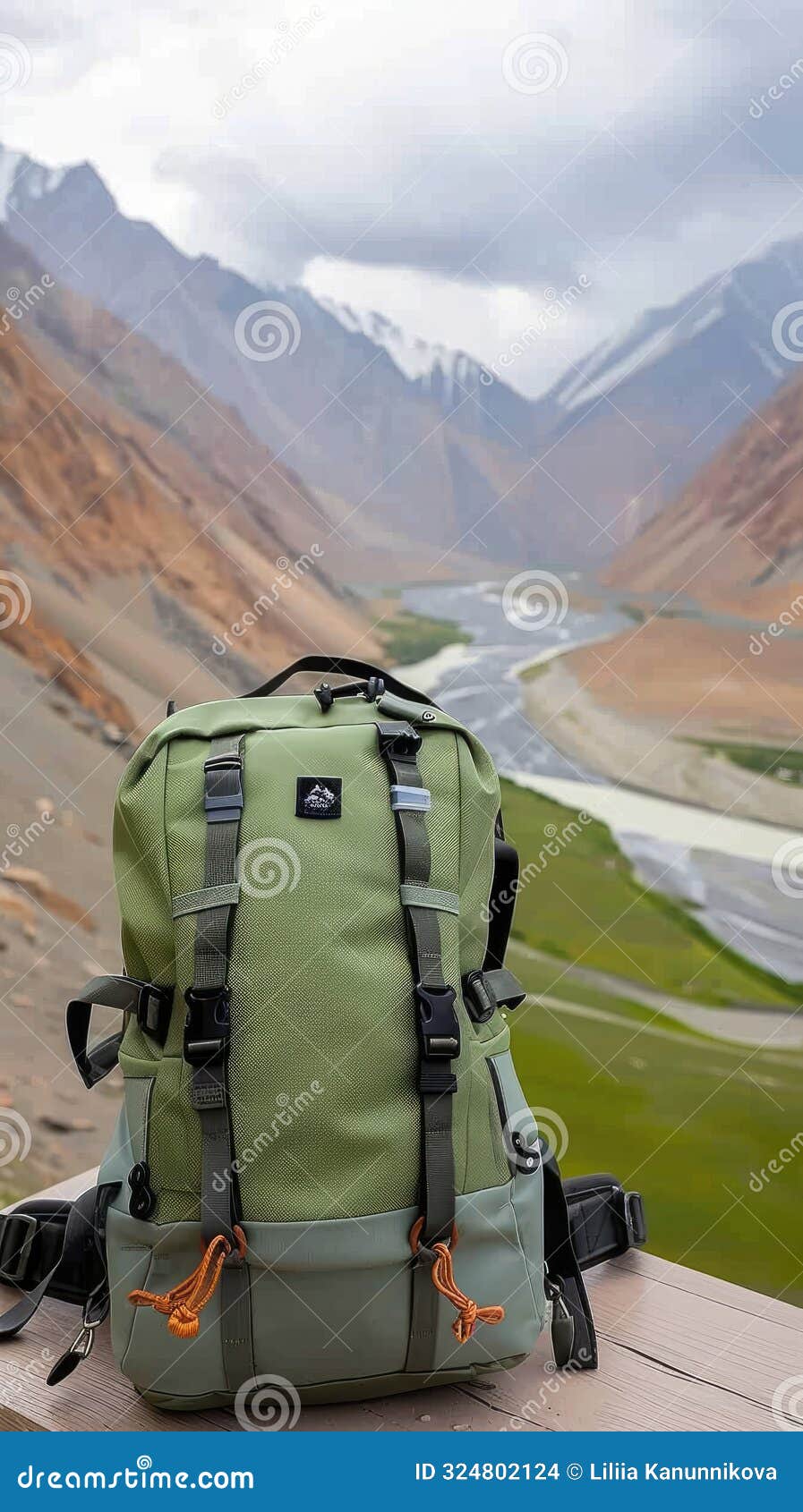 A Green Backpack and a White Hard Hat Sit on a Wooden Table in Front of ...
