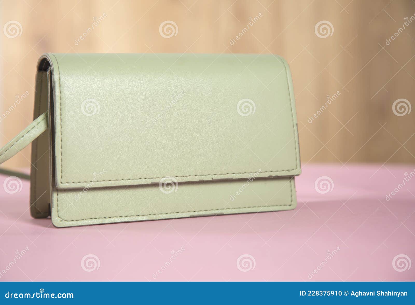 Green bag on table stock photo. Image of glamour, leather - 228375910