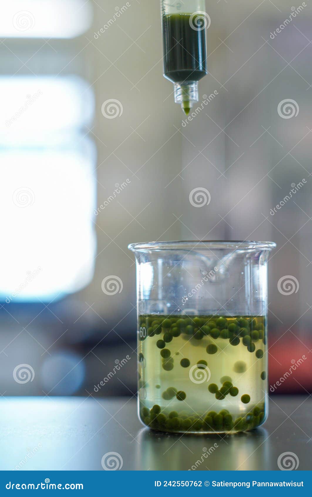 Green Bead in Lab Beaker and Syringe Stock Photo - Image of ...