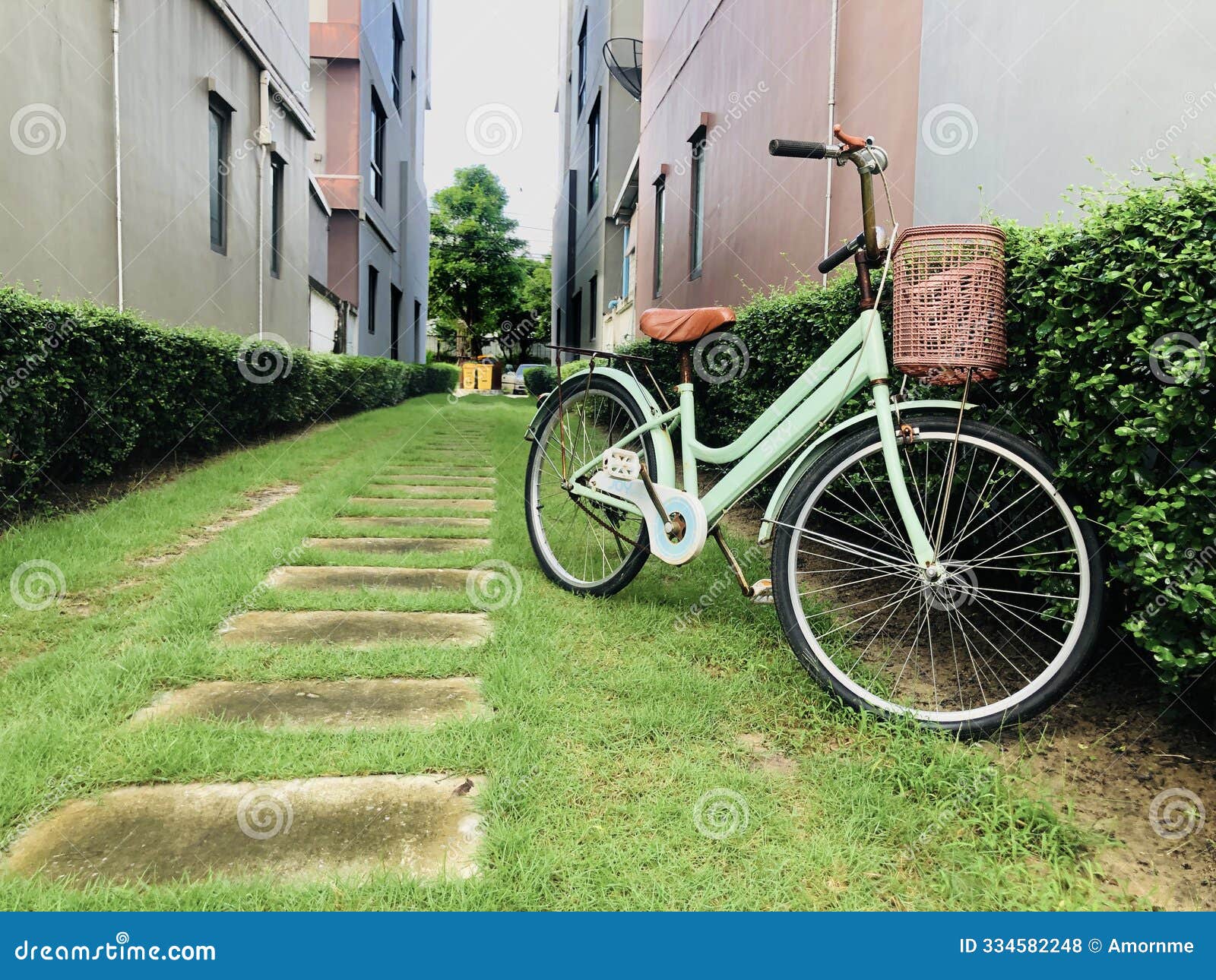 A Green Bicycle Parked on a Pathway in a Quiet Village Stock Photo ...