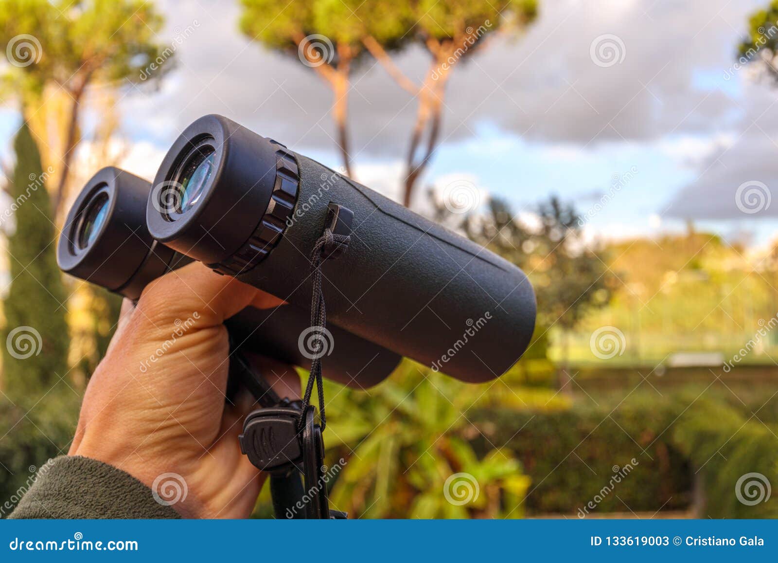 Green Binoculars in Hand stock image. Image of business - 133619003