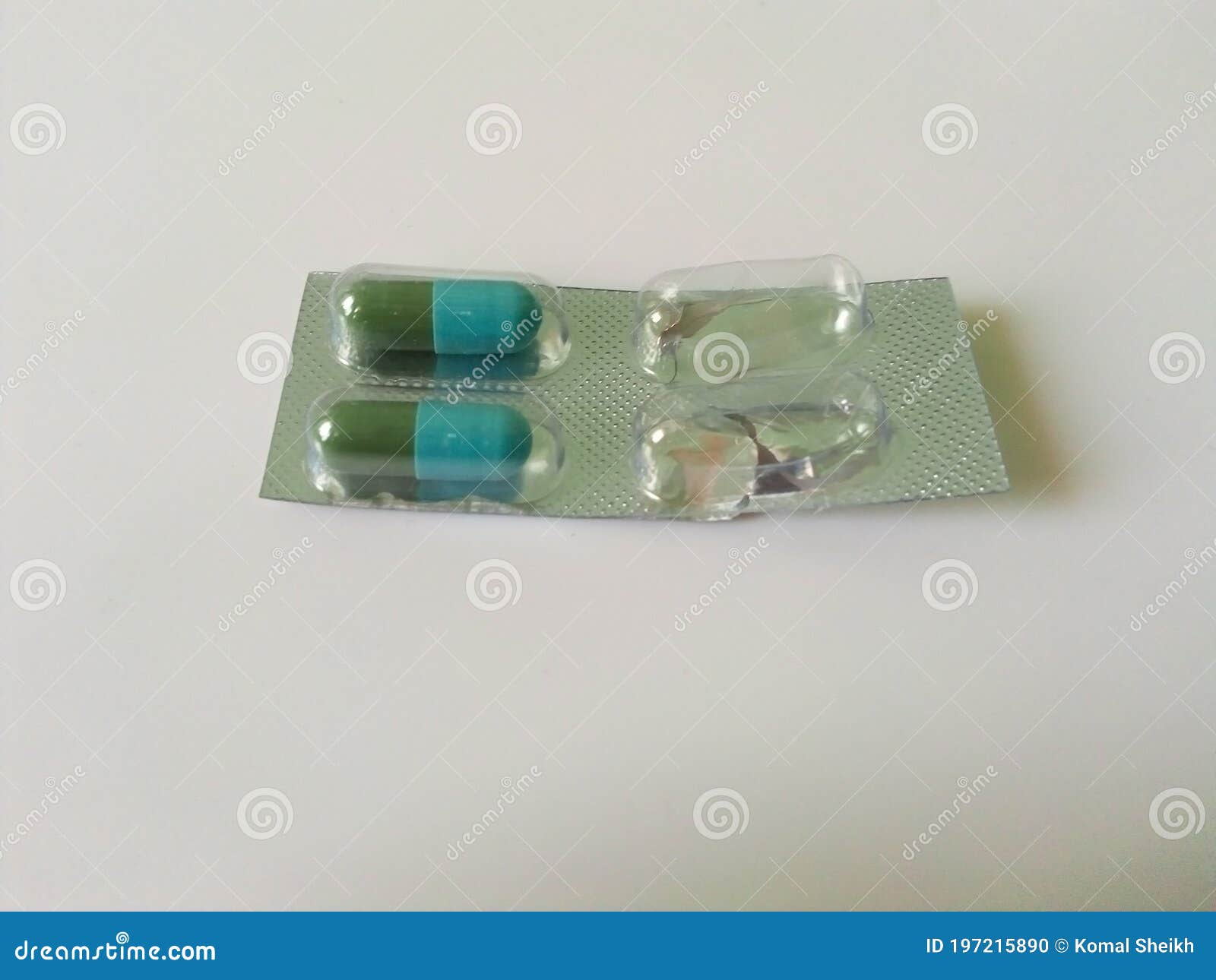 Green and Blue Capsules with Wrapper Stock Photo - Image of blue ...