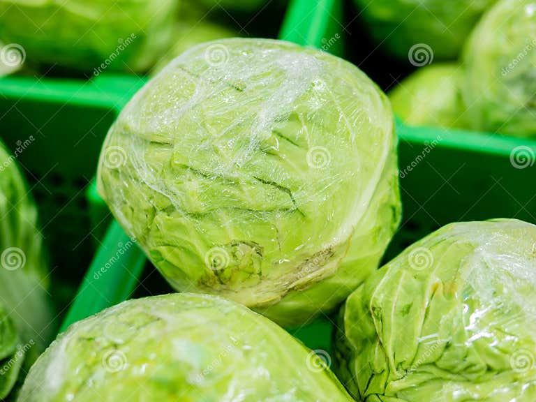 Green Cabbage in Plastic Boxes on the Counter of the Supermarket. Stock ...