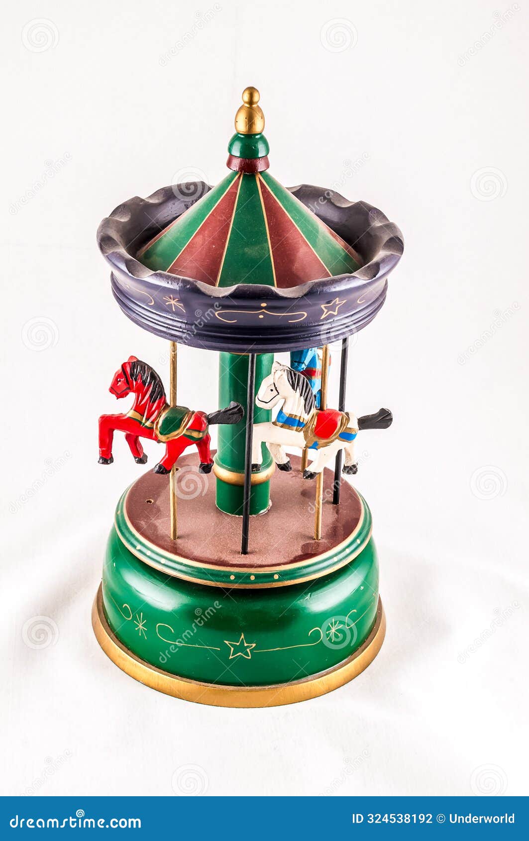 A Green Carousel with Horses and a Man on it Stock Photo - Image of ...