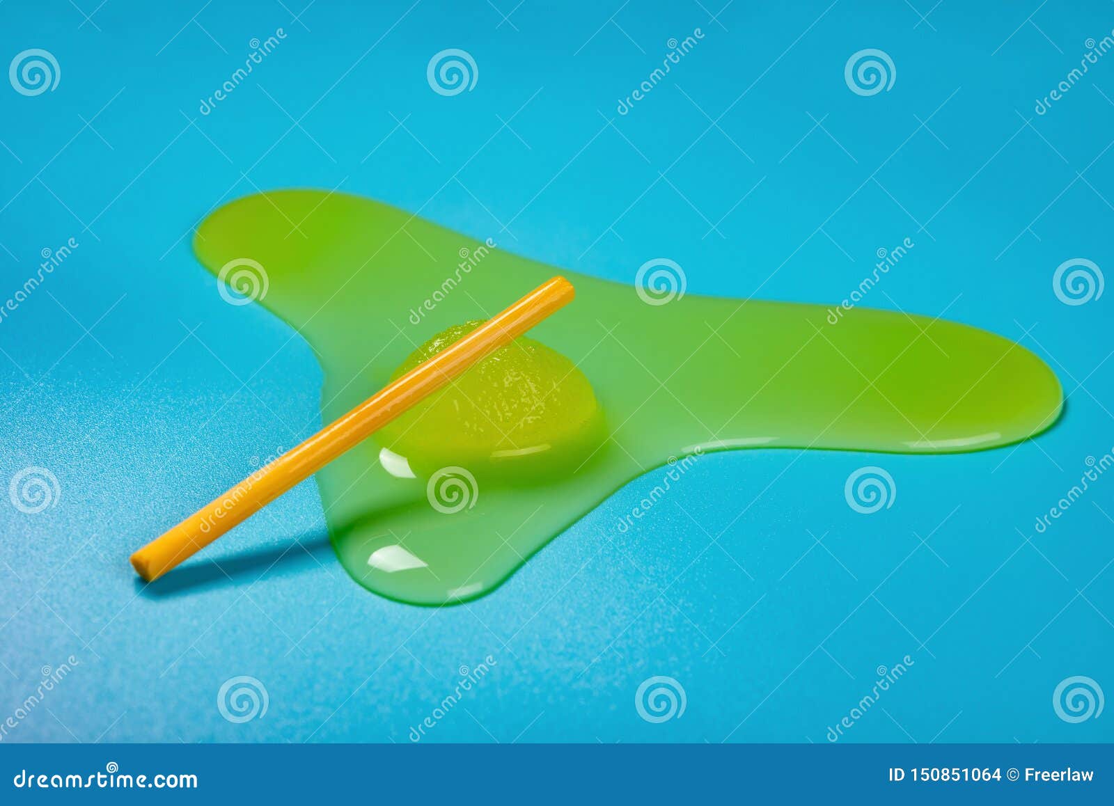 Green Color Mini Size Popsicle Melt on Blue Background Stock Photo ...