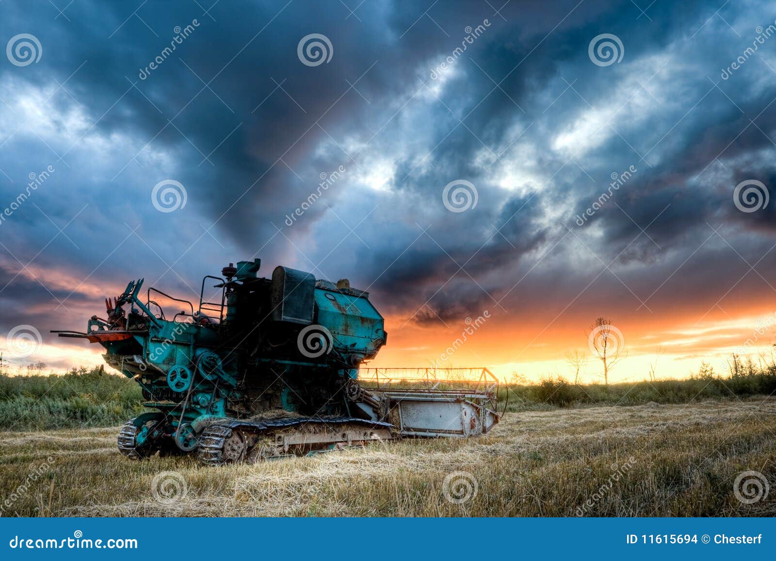 Green combine under sunset stock photo. Image of sinister - 11615694