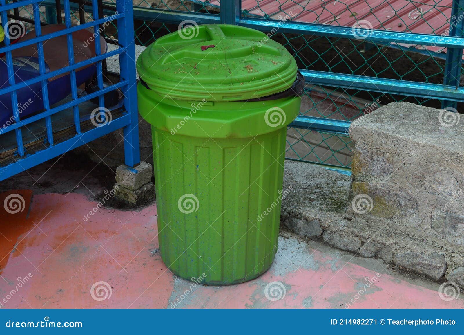 Green Dustbin on the Floor at the Roadside Stock Image - Image of ...