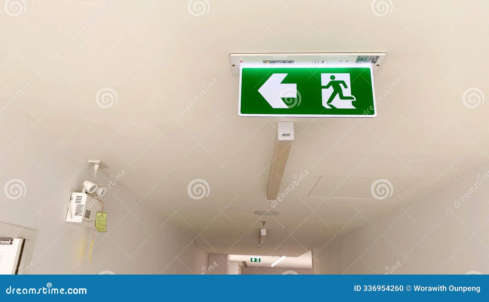 Green Emergency Exit Sign In Corridor Point Way Royalty-Free Stock ...