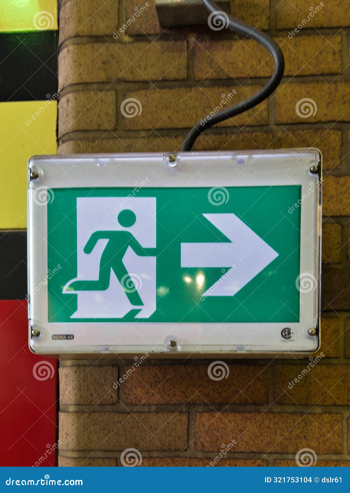 Green Emergency Exit Sign on Brick Wall Stock Photo - Image of ...