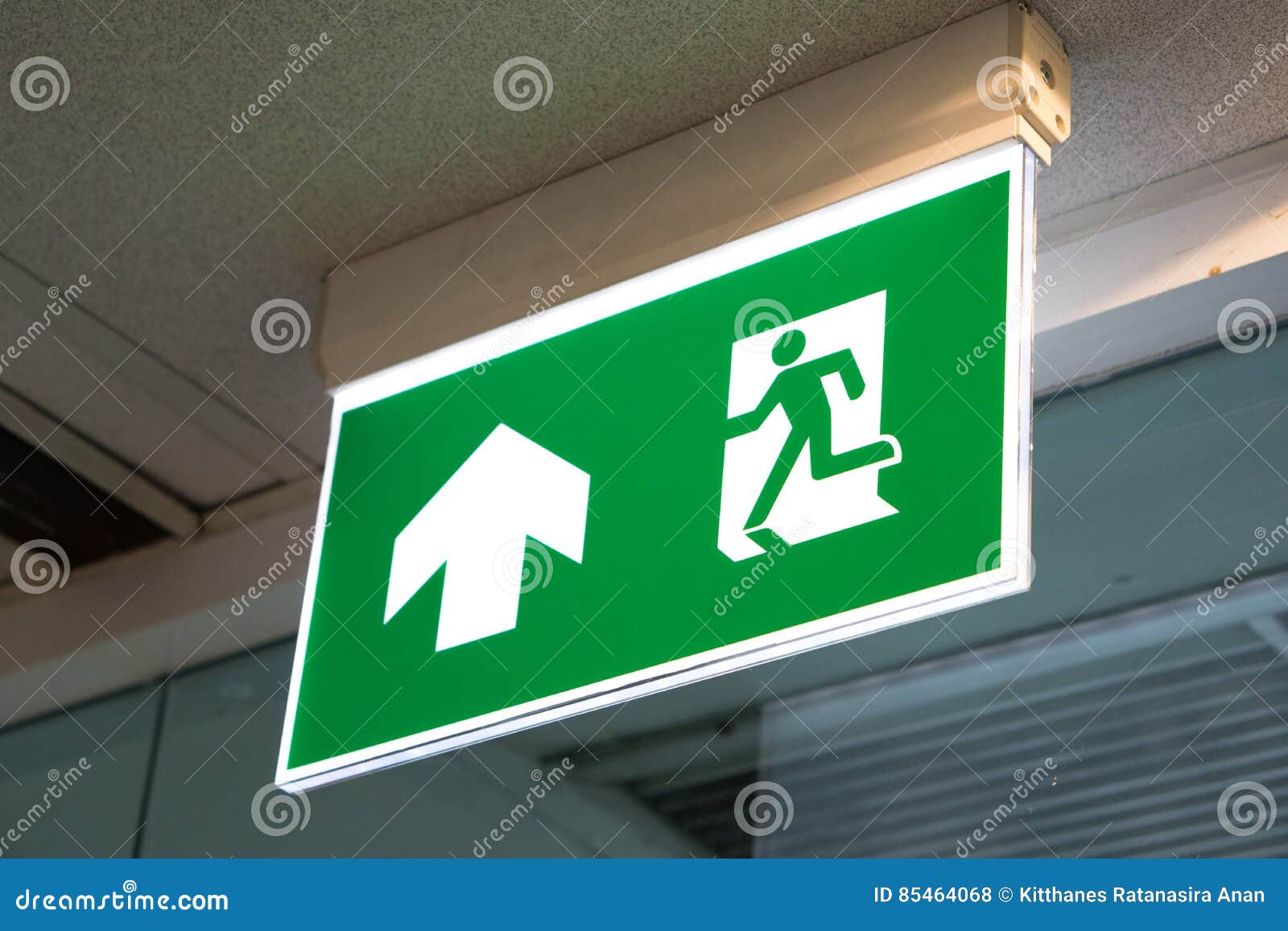 Green Emergency Exit Sign Showing the Way To Escape. Stock Photo ...
