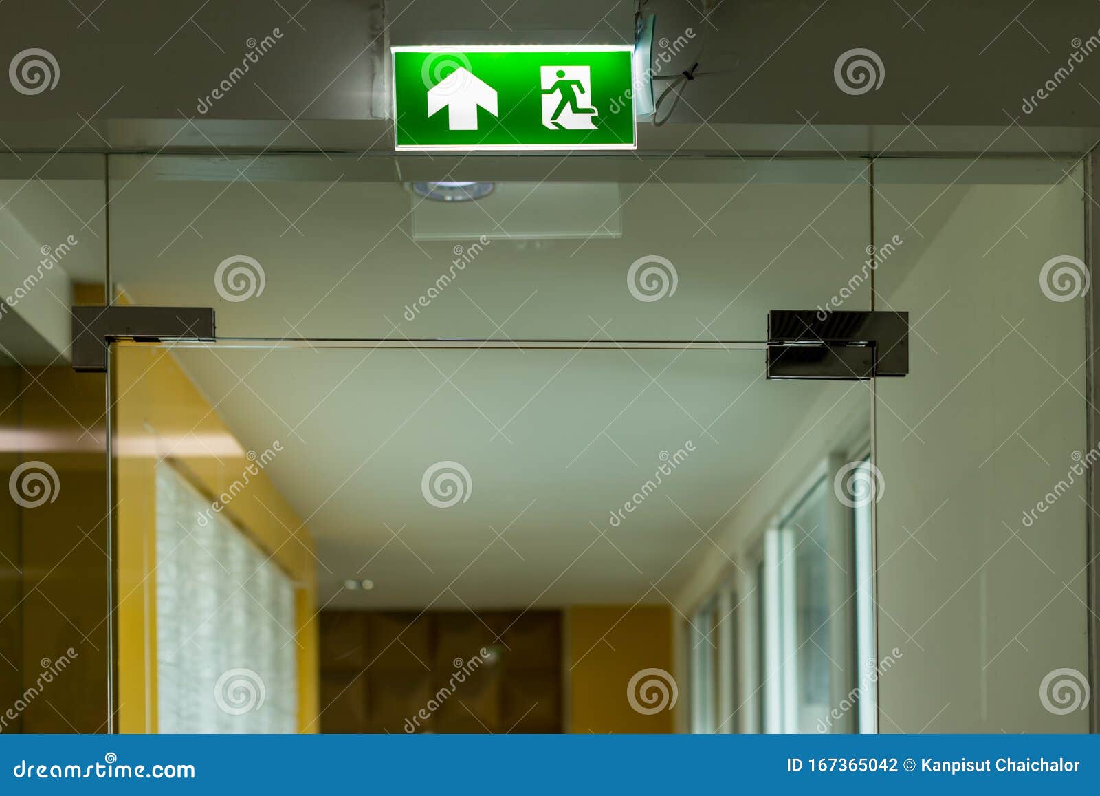 Green Emergency Exit Sign Showing the Way To Escape.Fire Exit in the ...