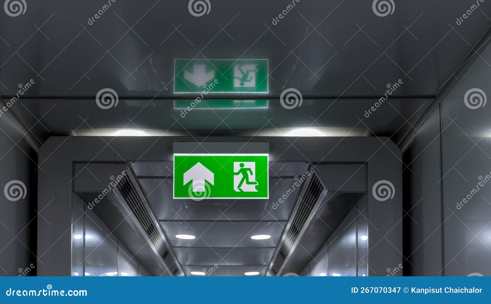 Green Emergency Exit Sign Showing the Way To Escape. Fire Exit in the ...