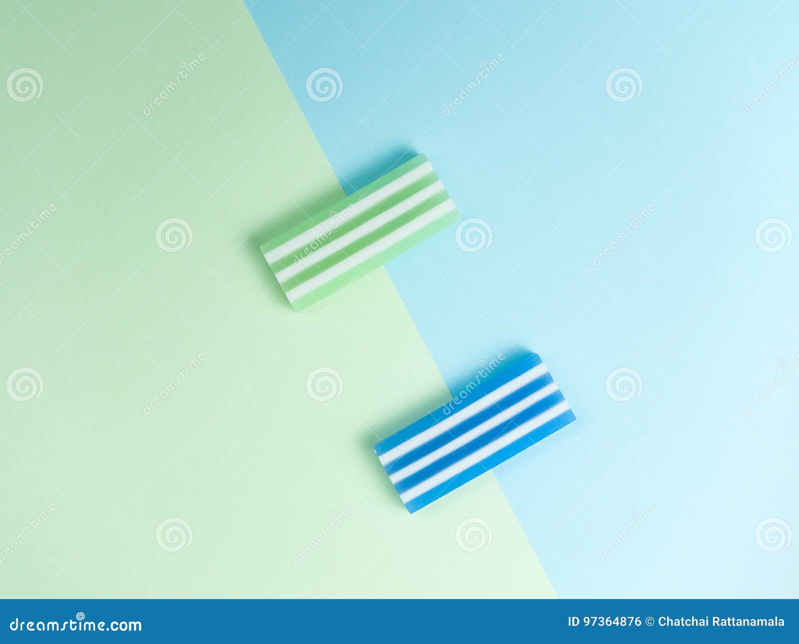 Green Eraser and Blue Eraser on Half Blue and Green Background Stock ...