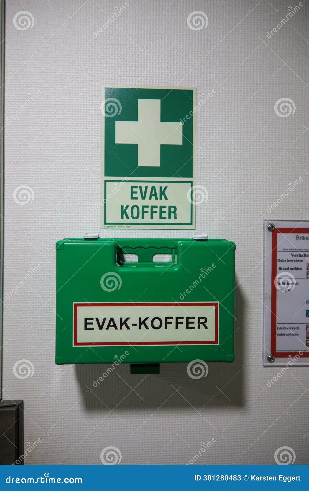 A Green Evacuation Case Hangs on the Wall Next To an Escape Plan Stock ...