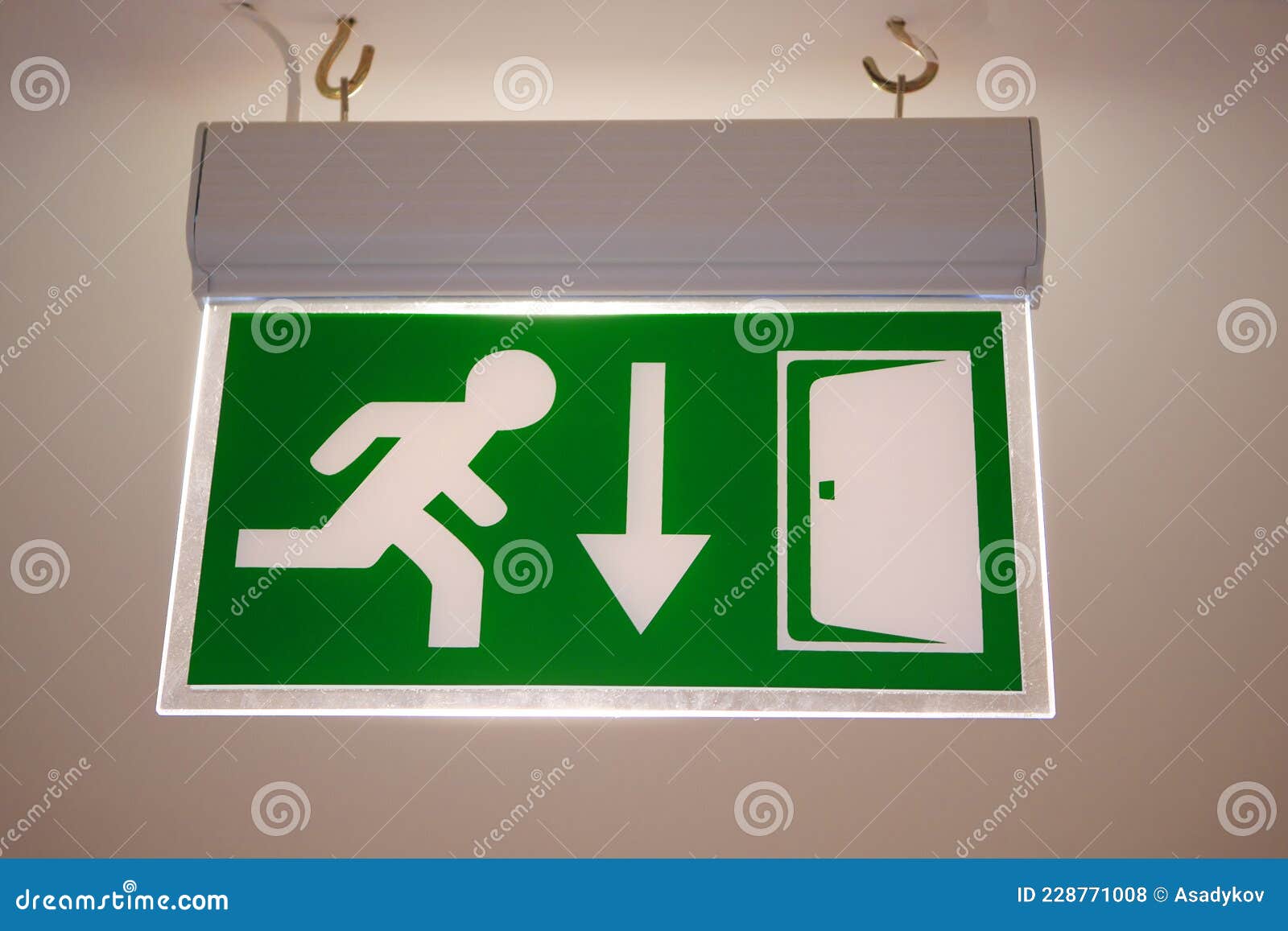 Green Evacuation Direction Sign on Ceiling. Emergency Exit Sign with ...