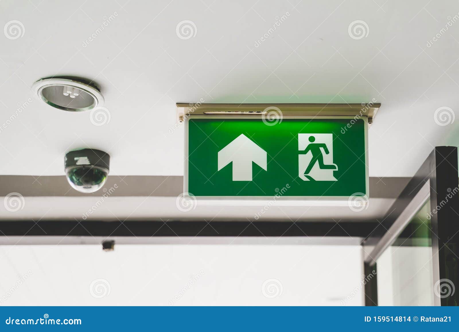 Fire Exit Sign on Ceiling with Opened Door for Emergency Case Stock ...