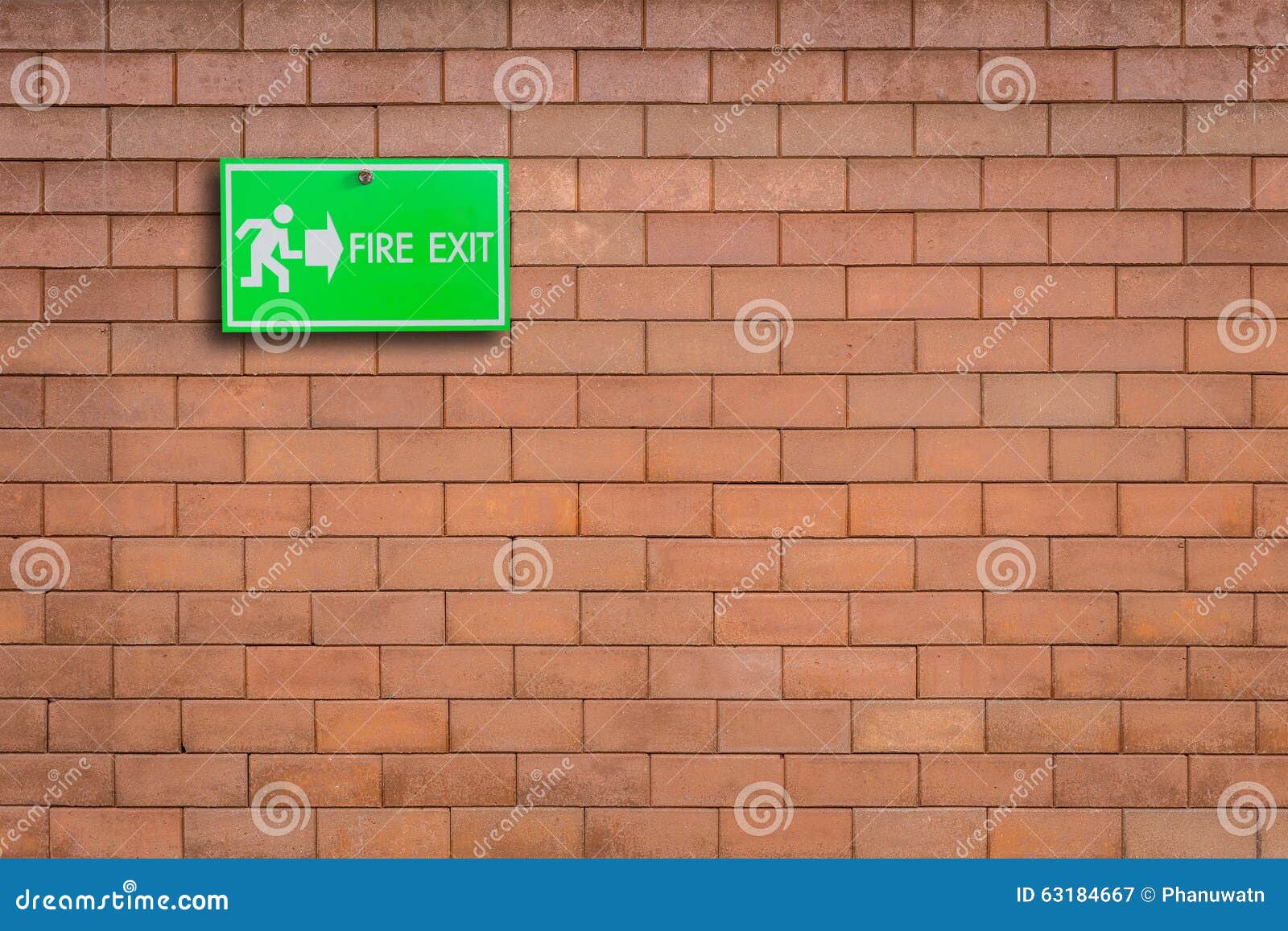 Green Fire Exit Sign on Stone Wall Stock Image - Image of safety ...
