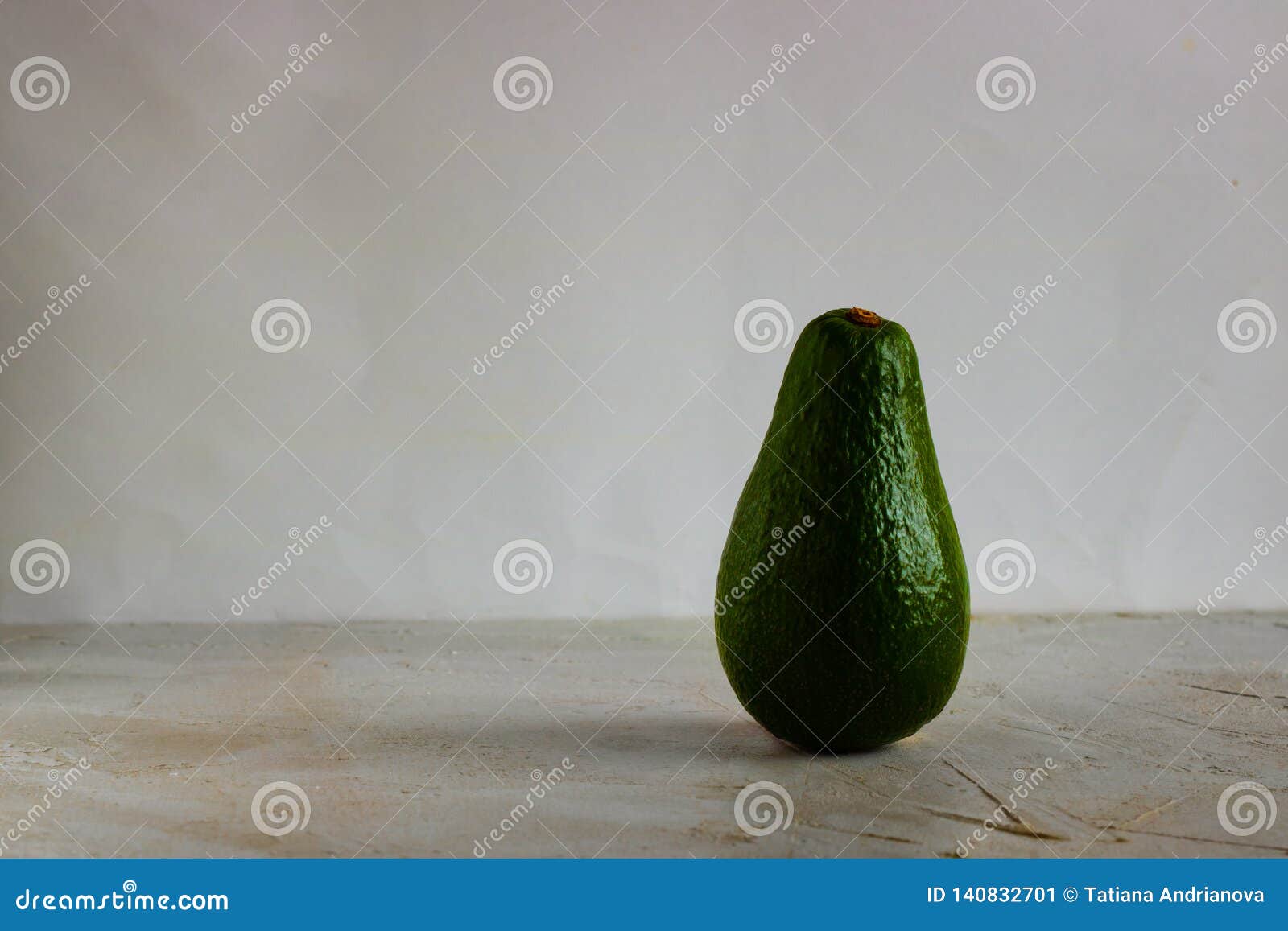 Green Fresh Avocado Standing on White and Grey Plain Empty Background ...