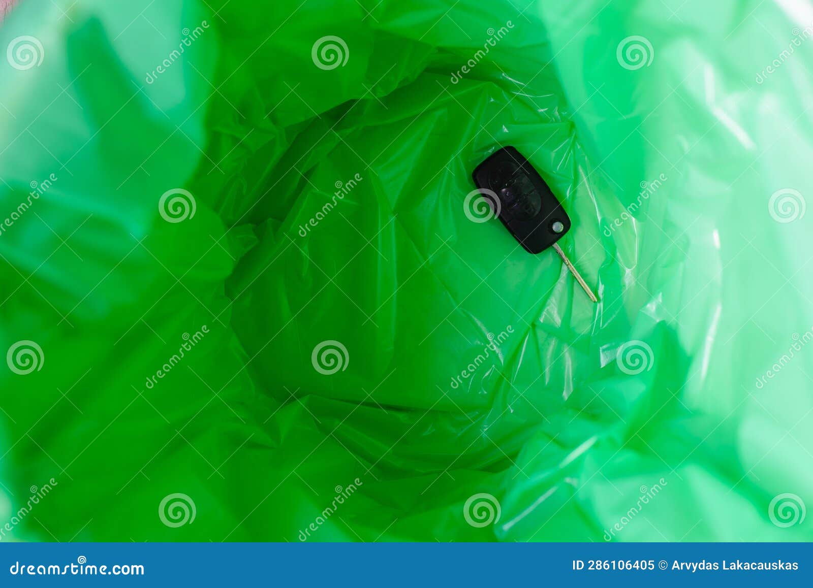 A Green Garbage Bag in the Trash. There is an Auto Key Inside Stock ...