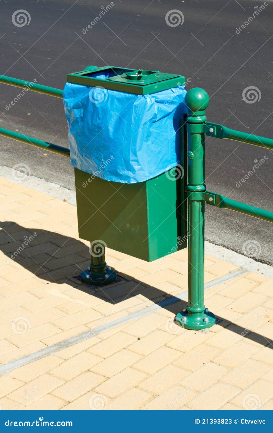 Red And Wet Garbage Basket In A Park On A Background Of Green Grass ...