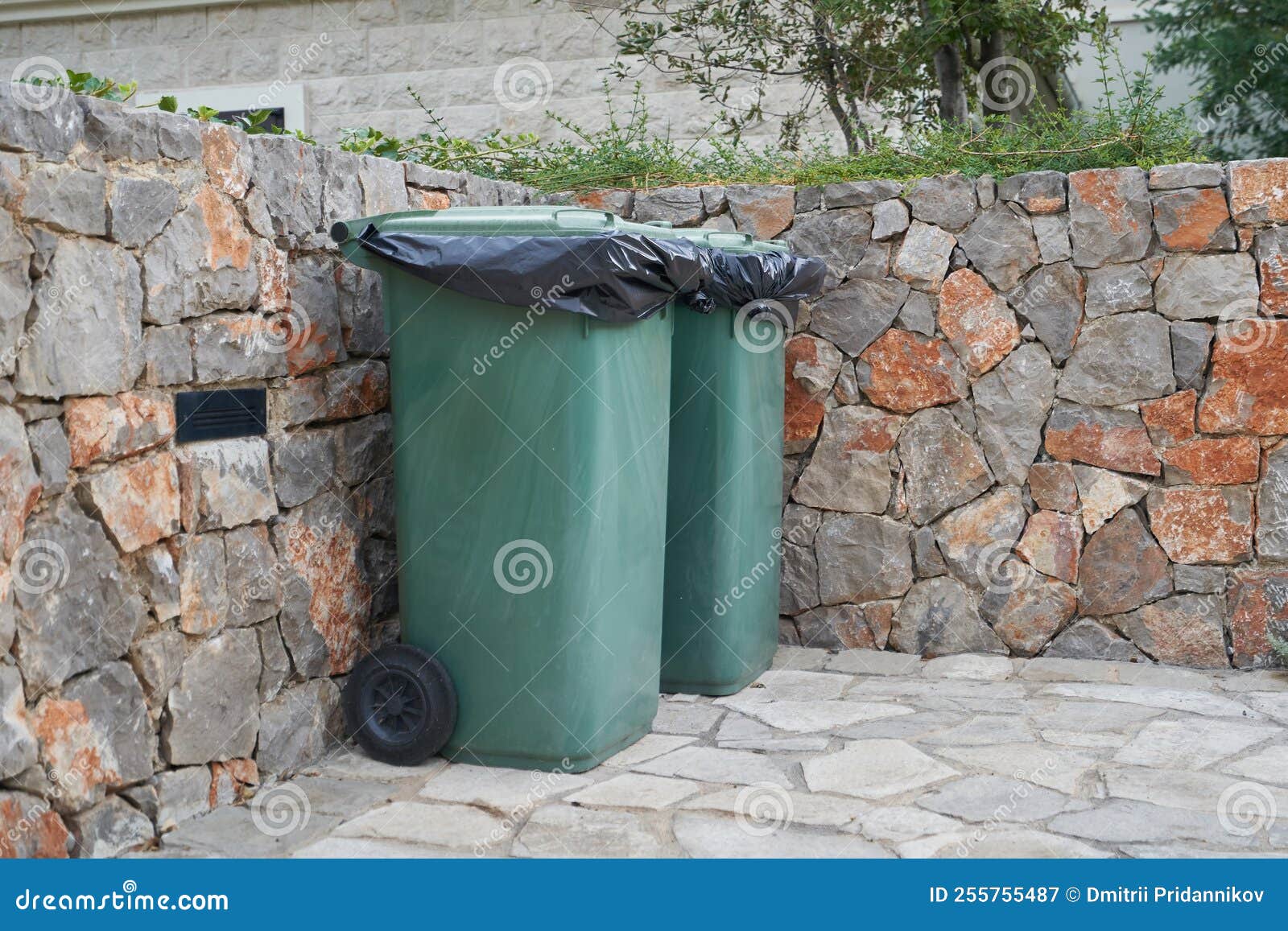 Green Garbage Cans Next To the Stone Wall Stock Image - Image of ...