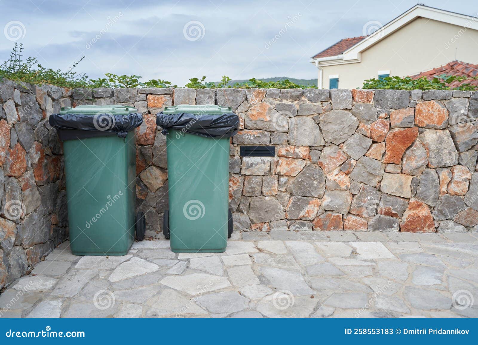 Green Garbage Cans Next To the Stone Wall Stock Image - Image of ...