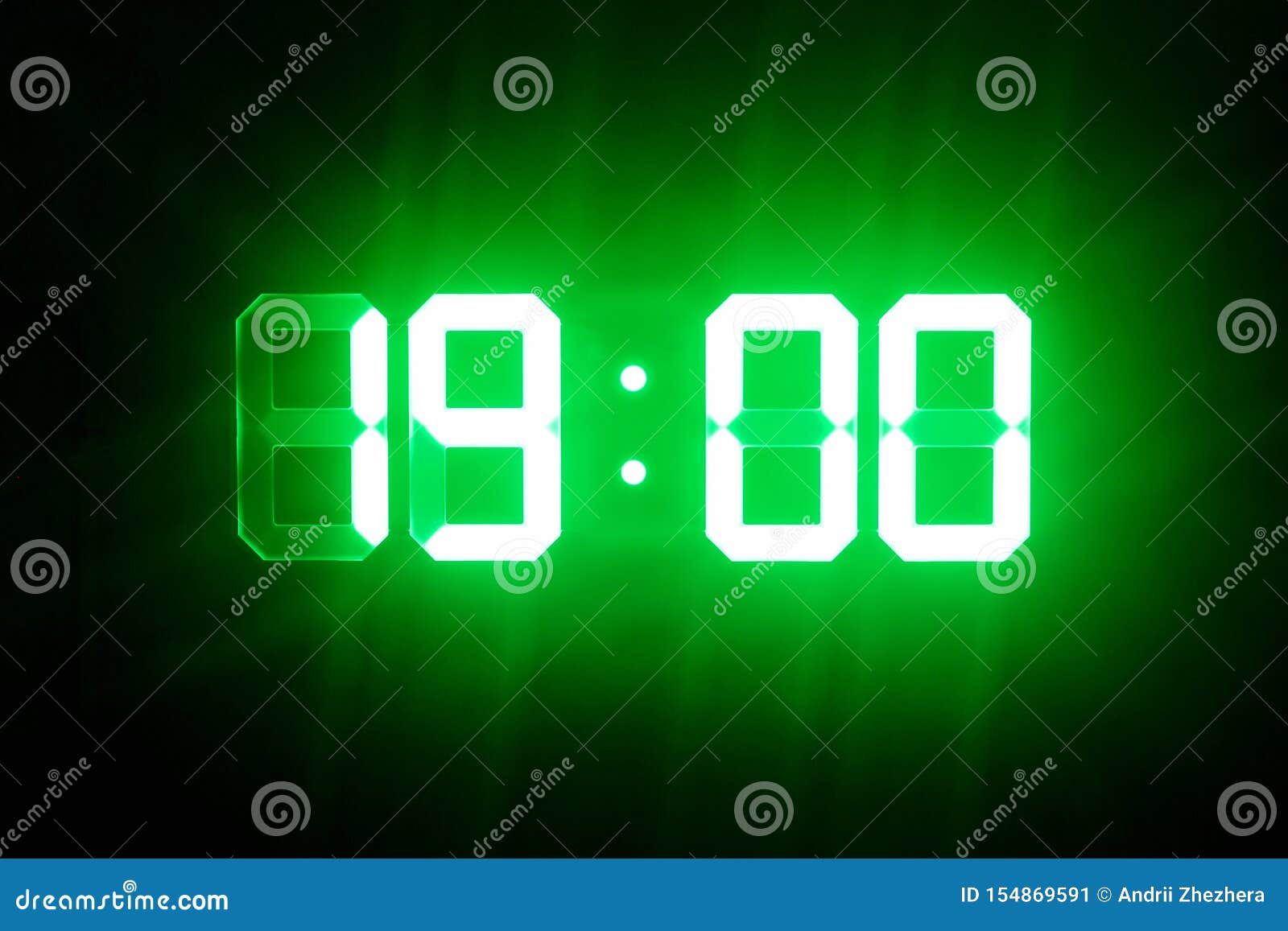 Green Glowing Digital Clocks in the Dark Show 19:00 Time Stock Image ...