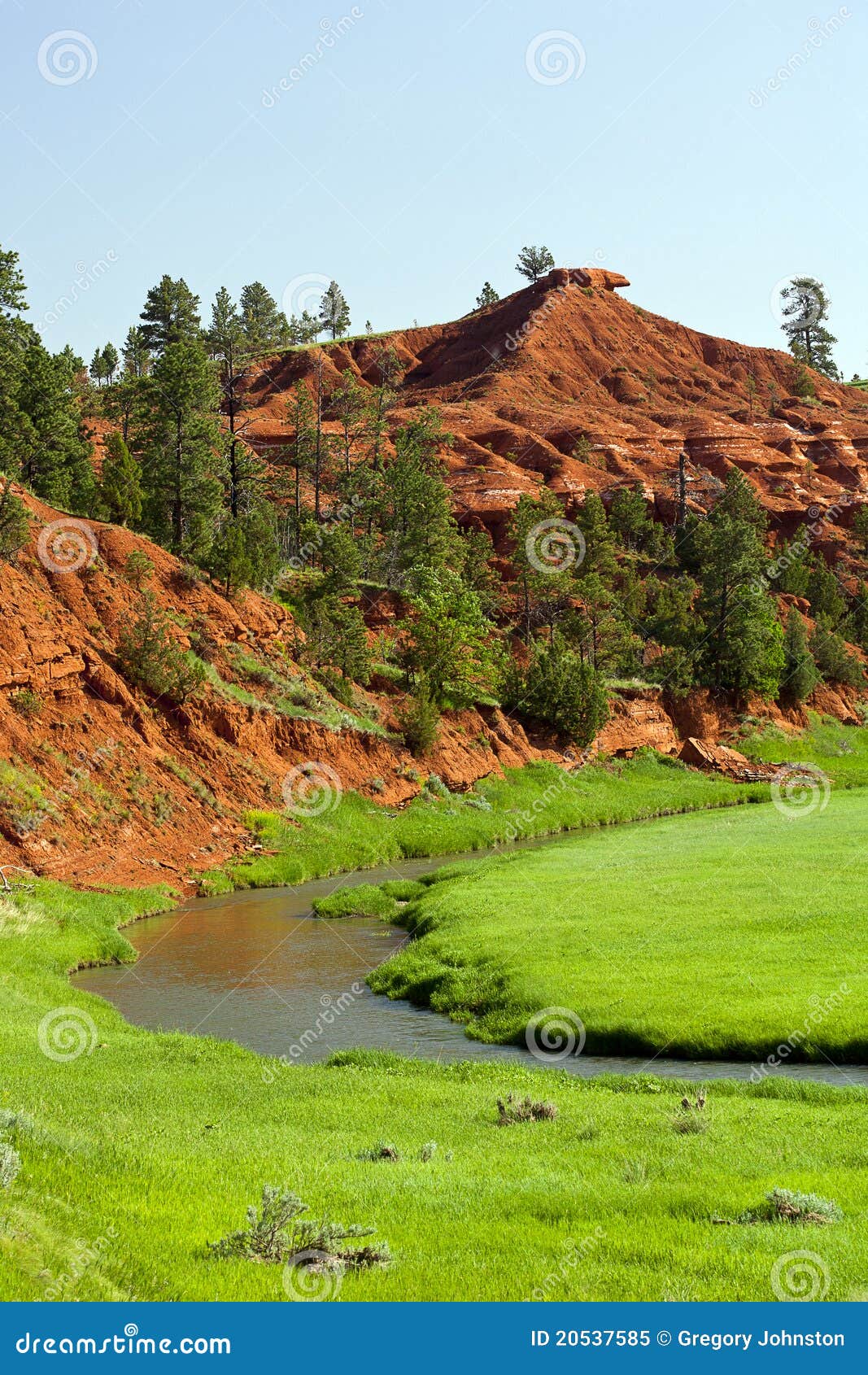 Green grass and red hills. stock image. Image of stream - 20537585