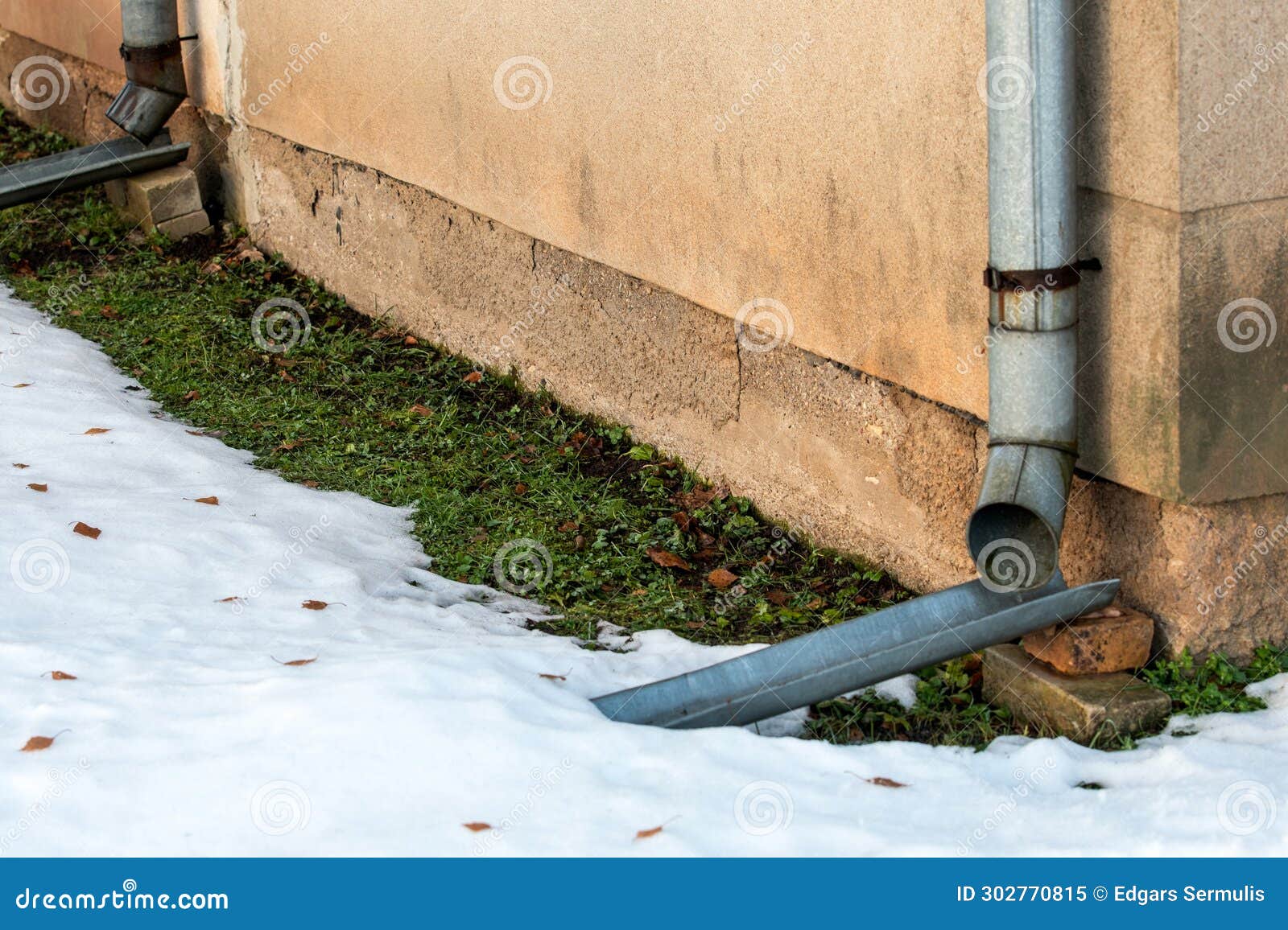 Green Grass in the Winter Foundations of House. Melting Snow Stock ...
