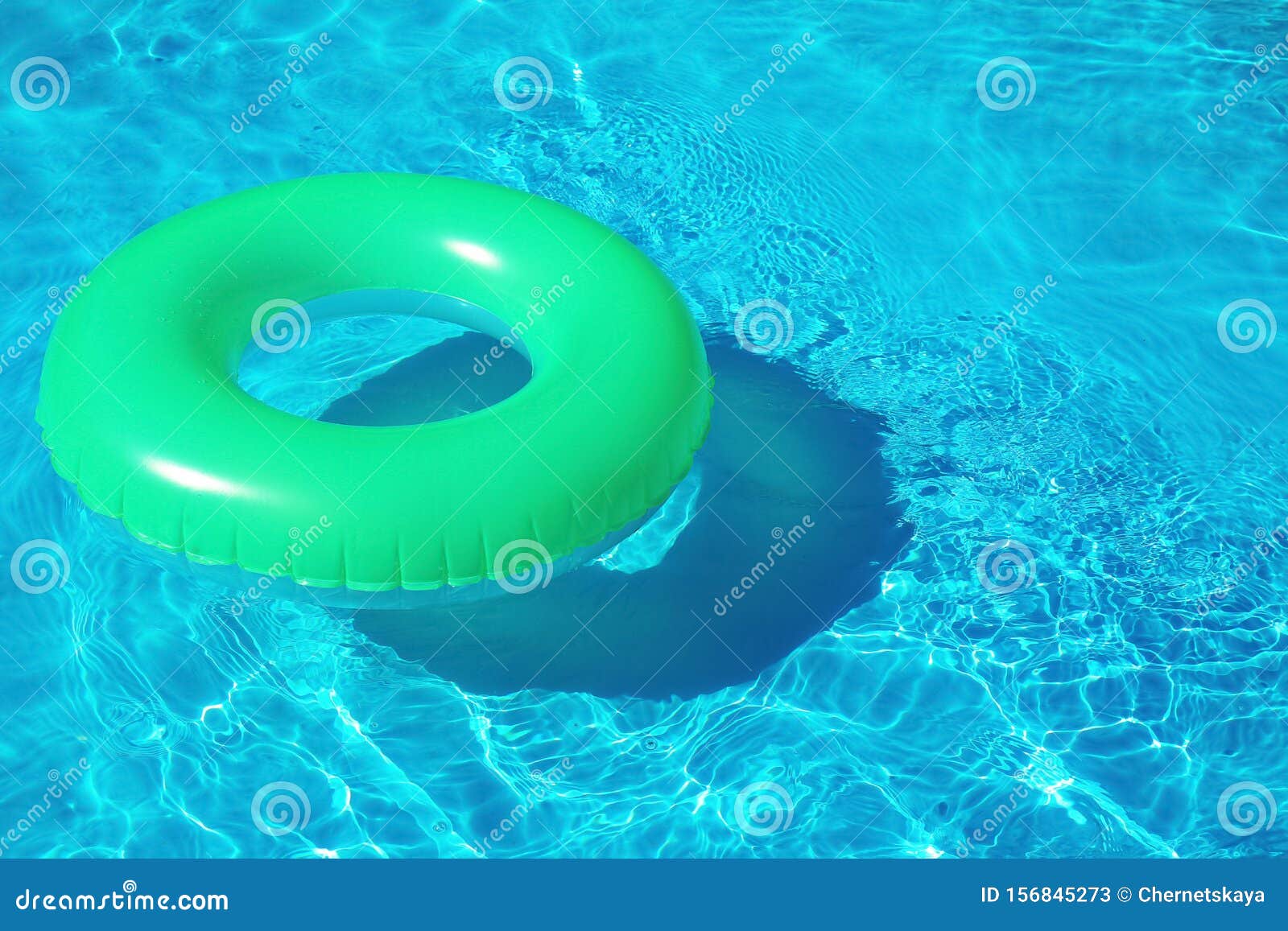 Green Inflatable Ring Floating in Swimming Pool on Sunny Day Stock ...