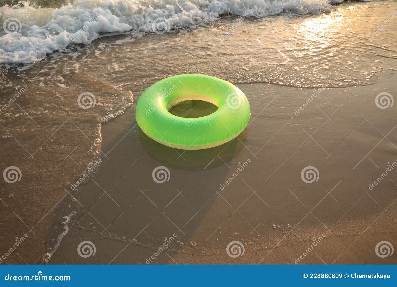 Green Inflatable Ring on Sandy Beach Near Sea, Space for Text Stock ...