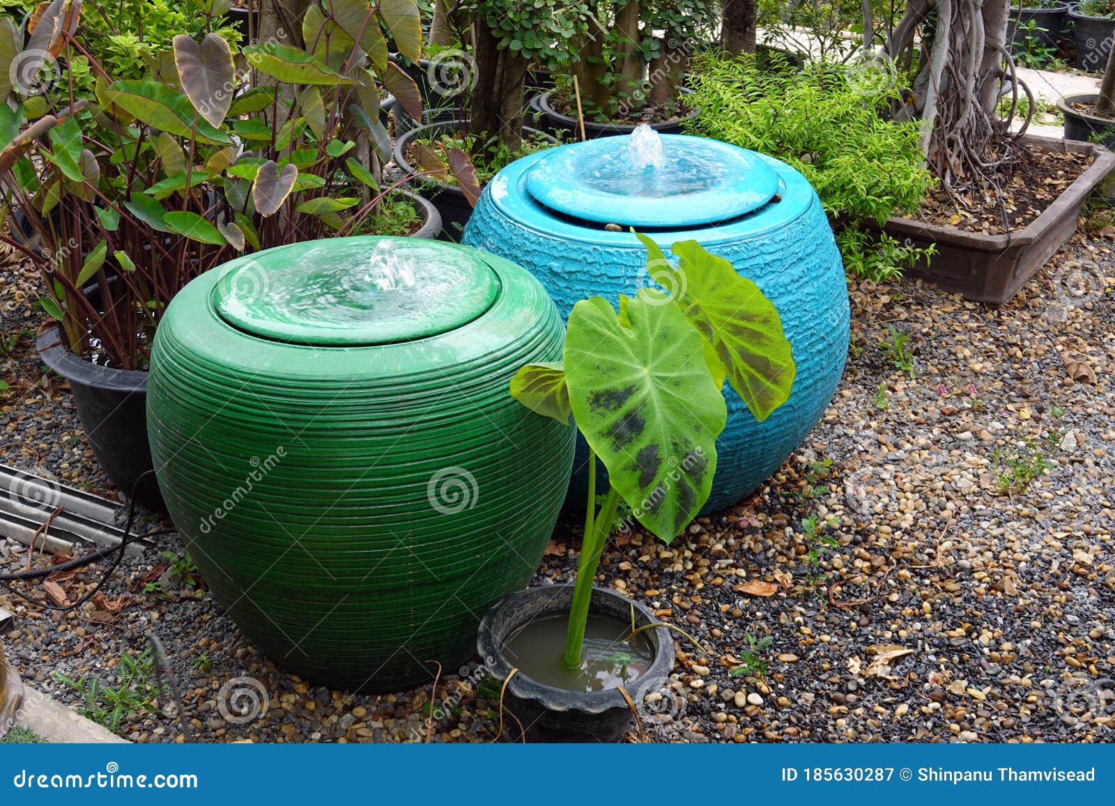 Green Jar and Blue Jar of Water Springing.,Jar with Flowing Water ...