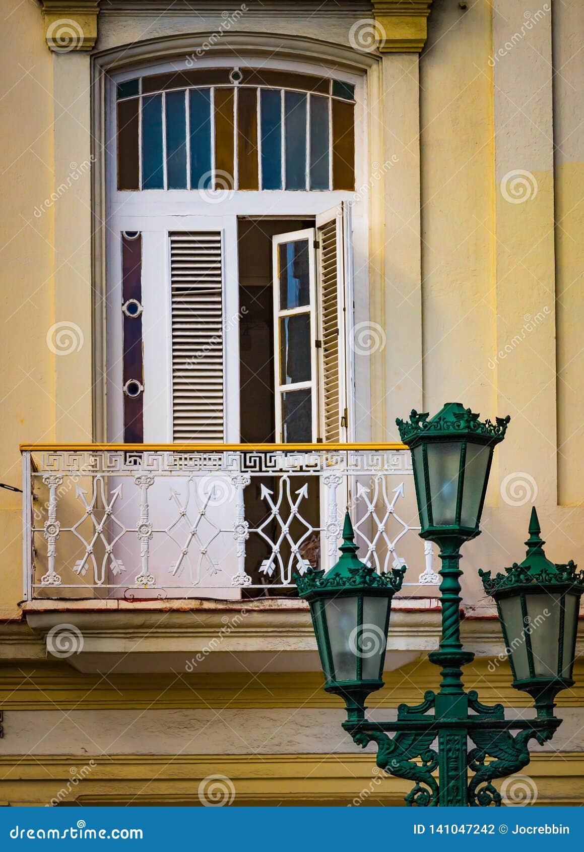 Green Lanterns Stand before White Shuttered Windows in Cuba Stock Photo ...