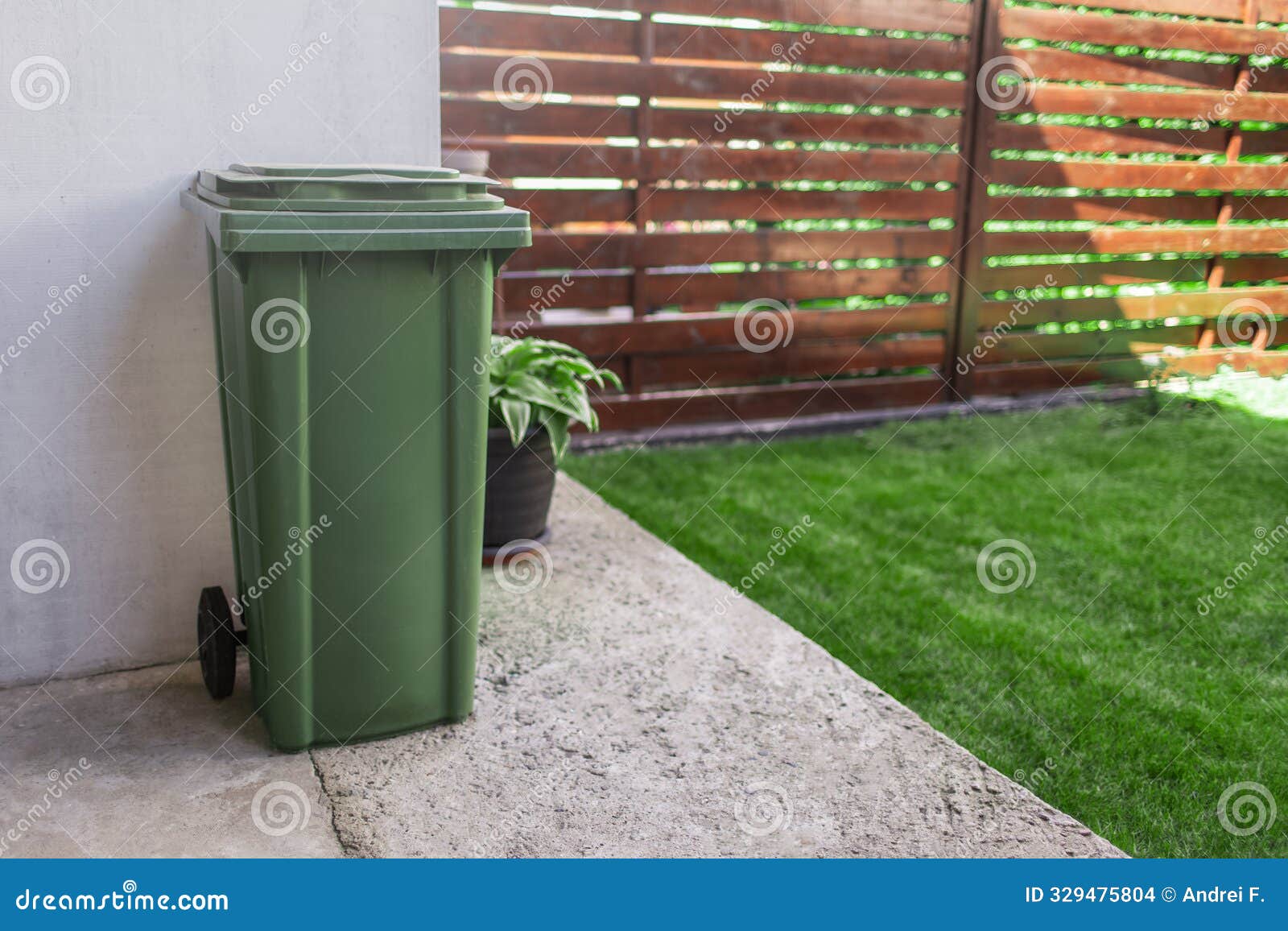 Green Large Plastic Bin for Trash on Backyard Stock Photo - Image of ...