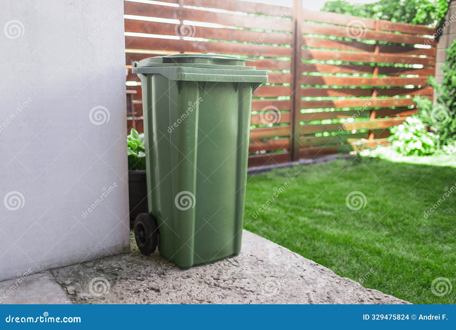 Green Large Plastic Bin for Trash on Backyard Stock Photo - Image of ...