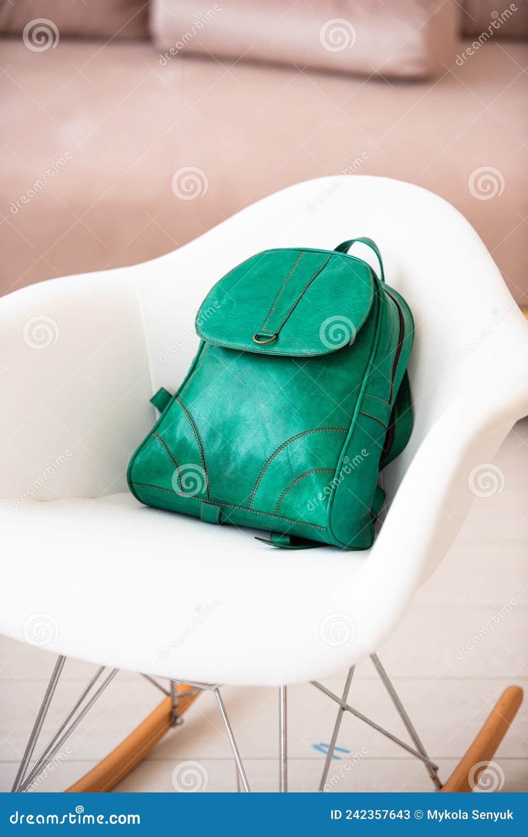 A Green Leather Modern Backpack on a White Chair Stock Image - Image of ...
