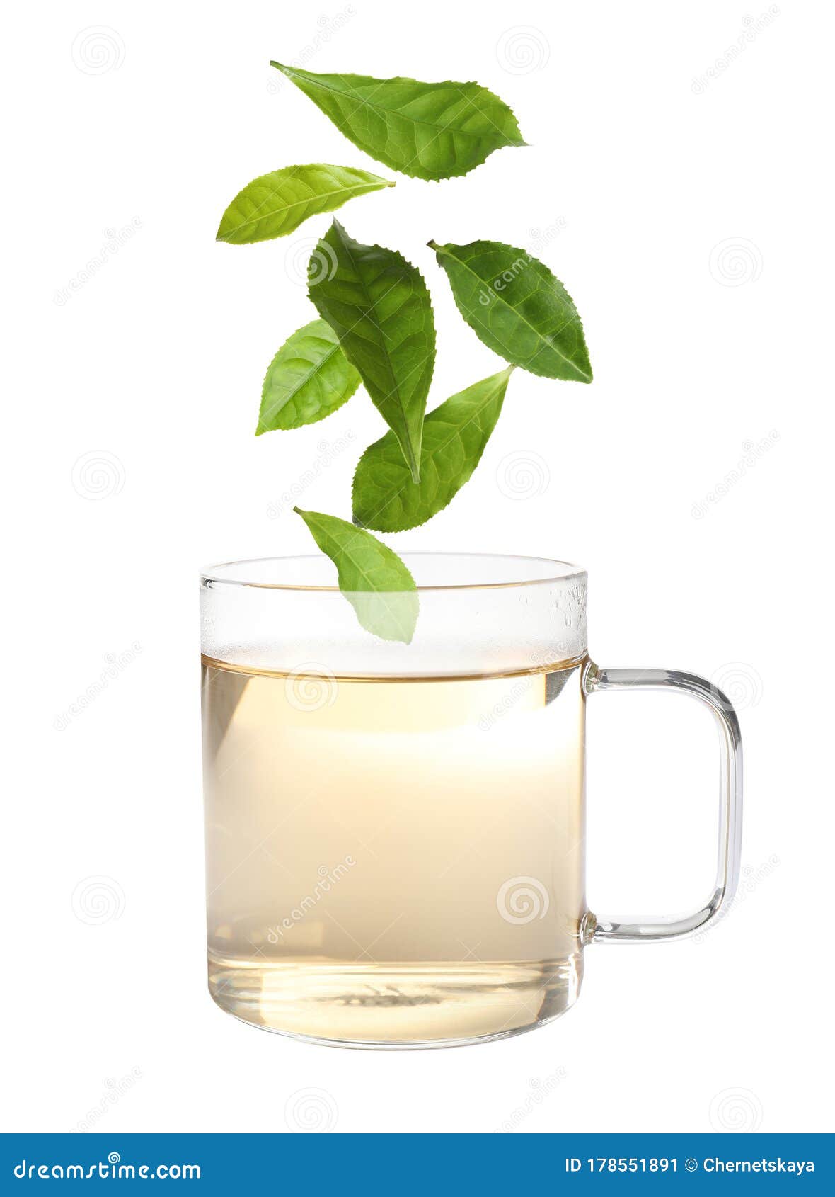 Green Leaves Falling into Cup of Tea on Background Stock Image - Image ...