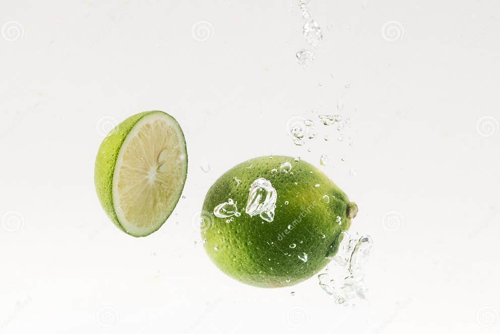 Lime Floating in Bubbling Water on White Background Stock Image - Image ...