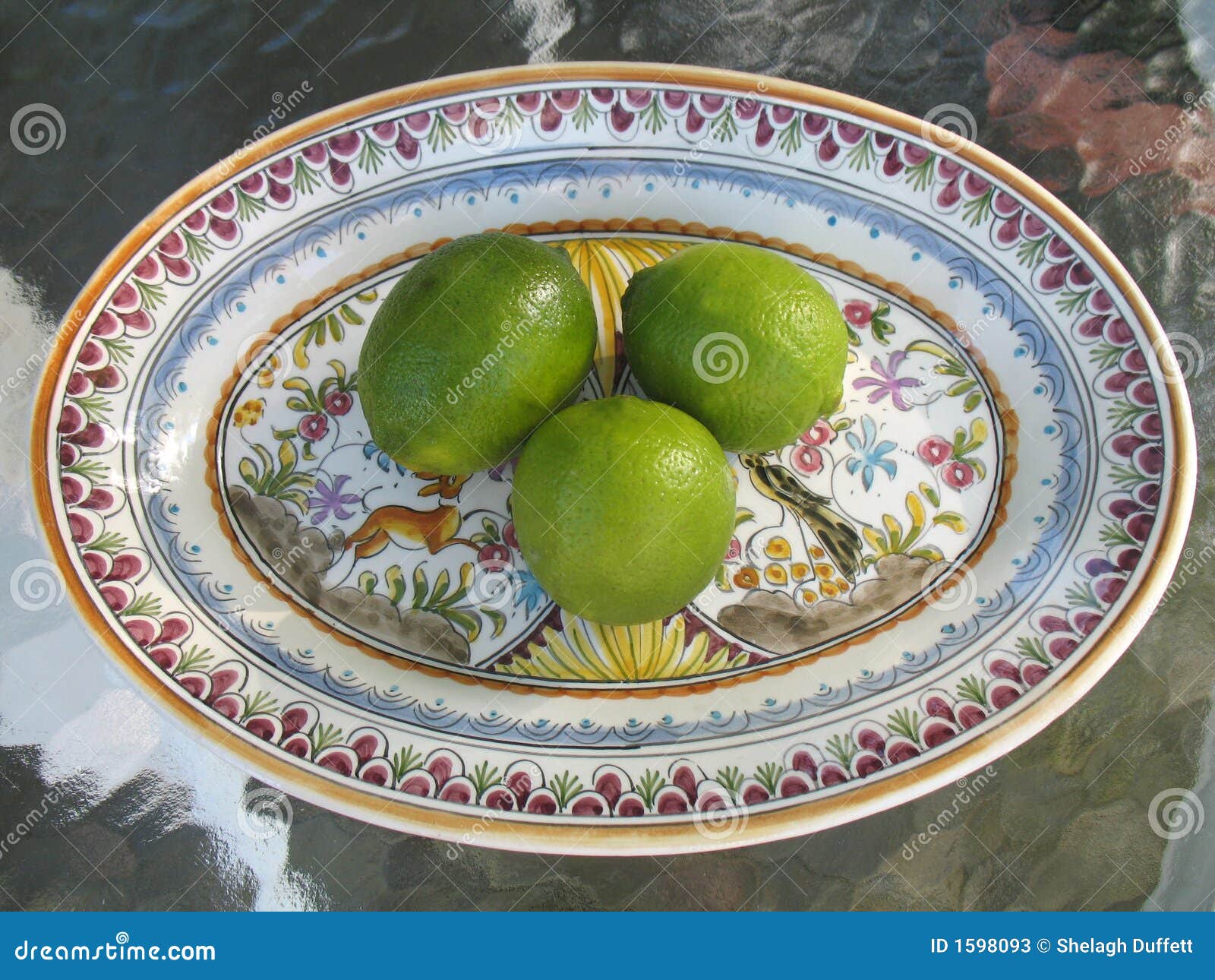 Green limes on plate stock image. Image of healthy, culinary - 1598093