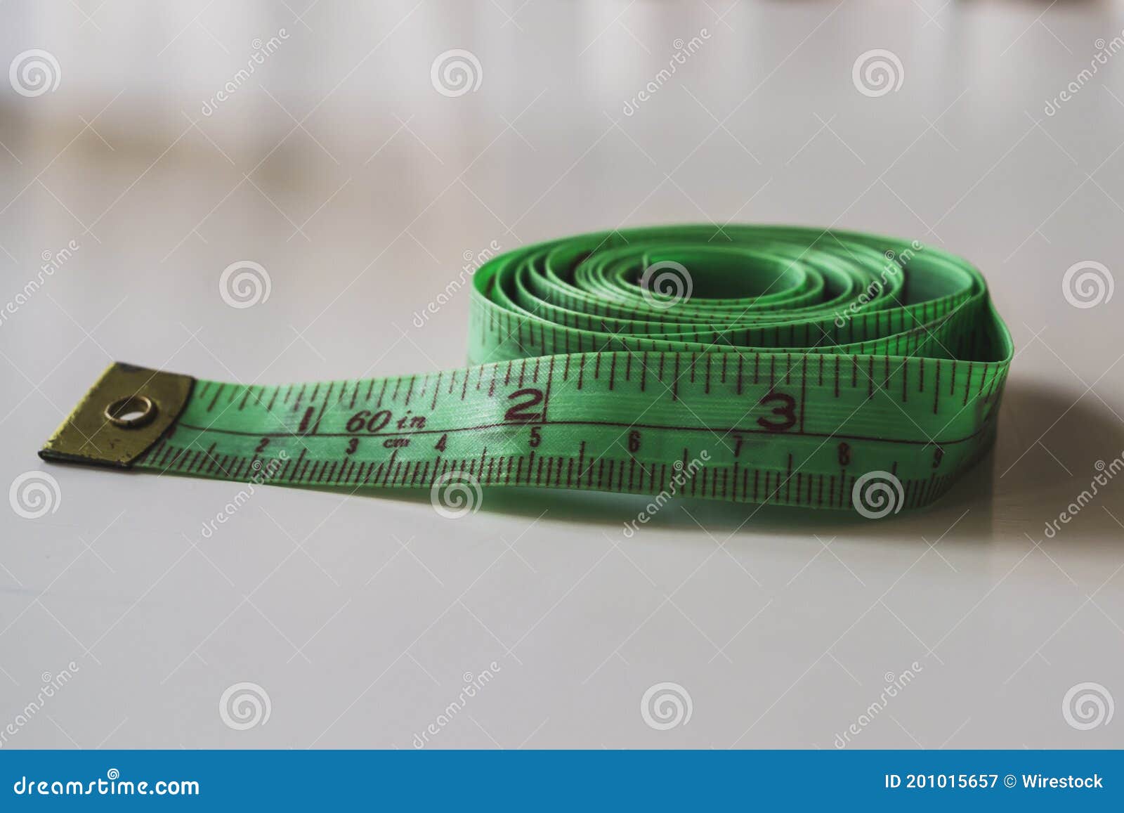 Green Measuring Tape on a White Surface Stock Image - Image of green ...