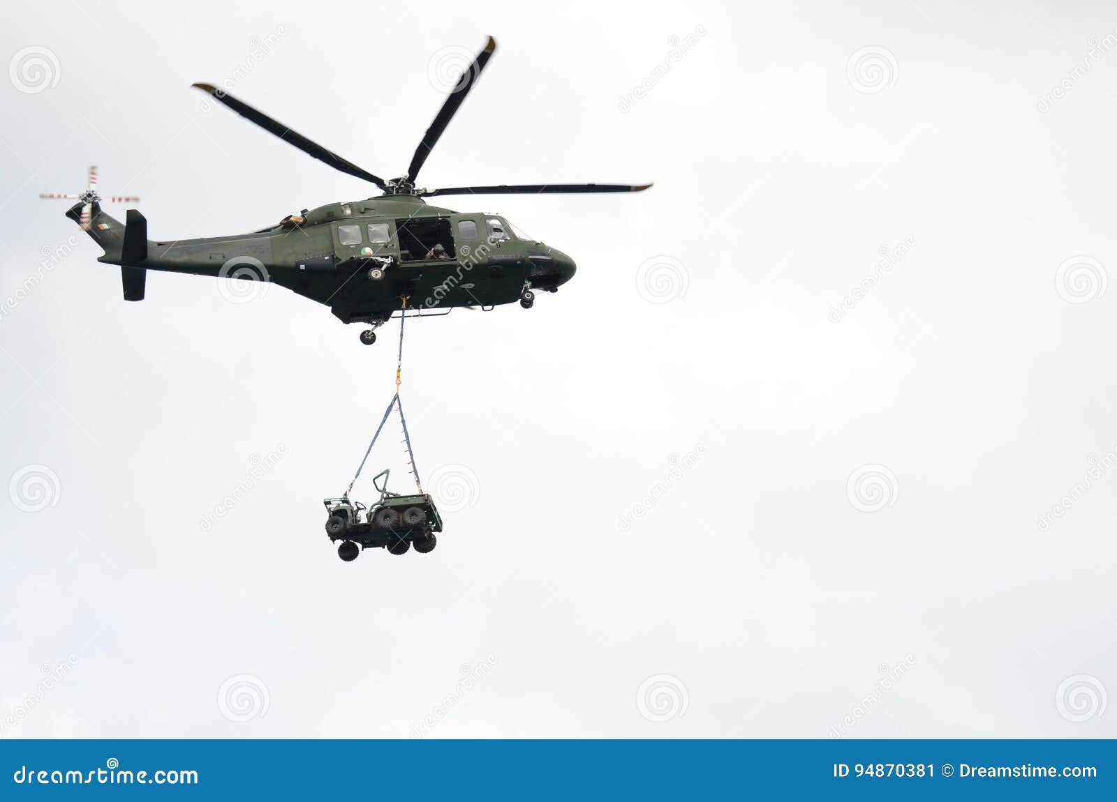Green Military Helicopter Carrying a Jeep Stock Image - Image of clouds ...