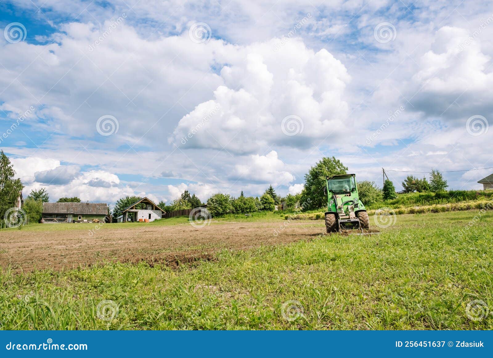 A Green Mini Skid Steer Loader Clear the Construction Site. Land Work ...