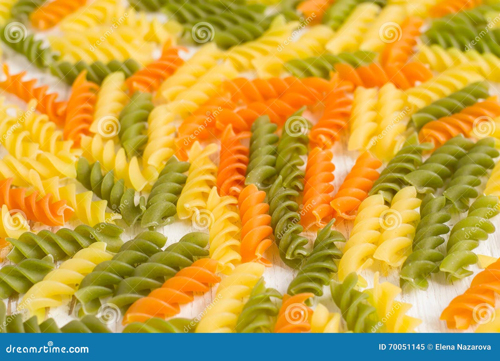 Green, Orange and Yellow Fusilli Pasta Background, Selective Foc Stock ...