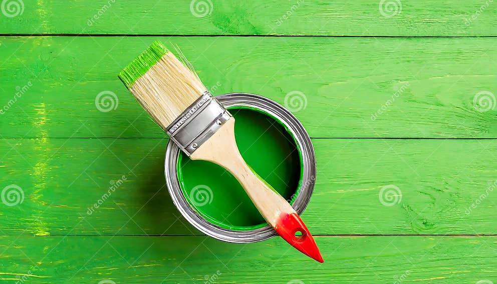 A Green Paint Can with a Red Handle is Sitting on a Green Surface Stock ...
