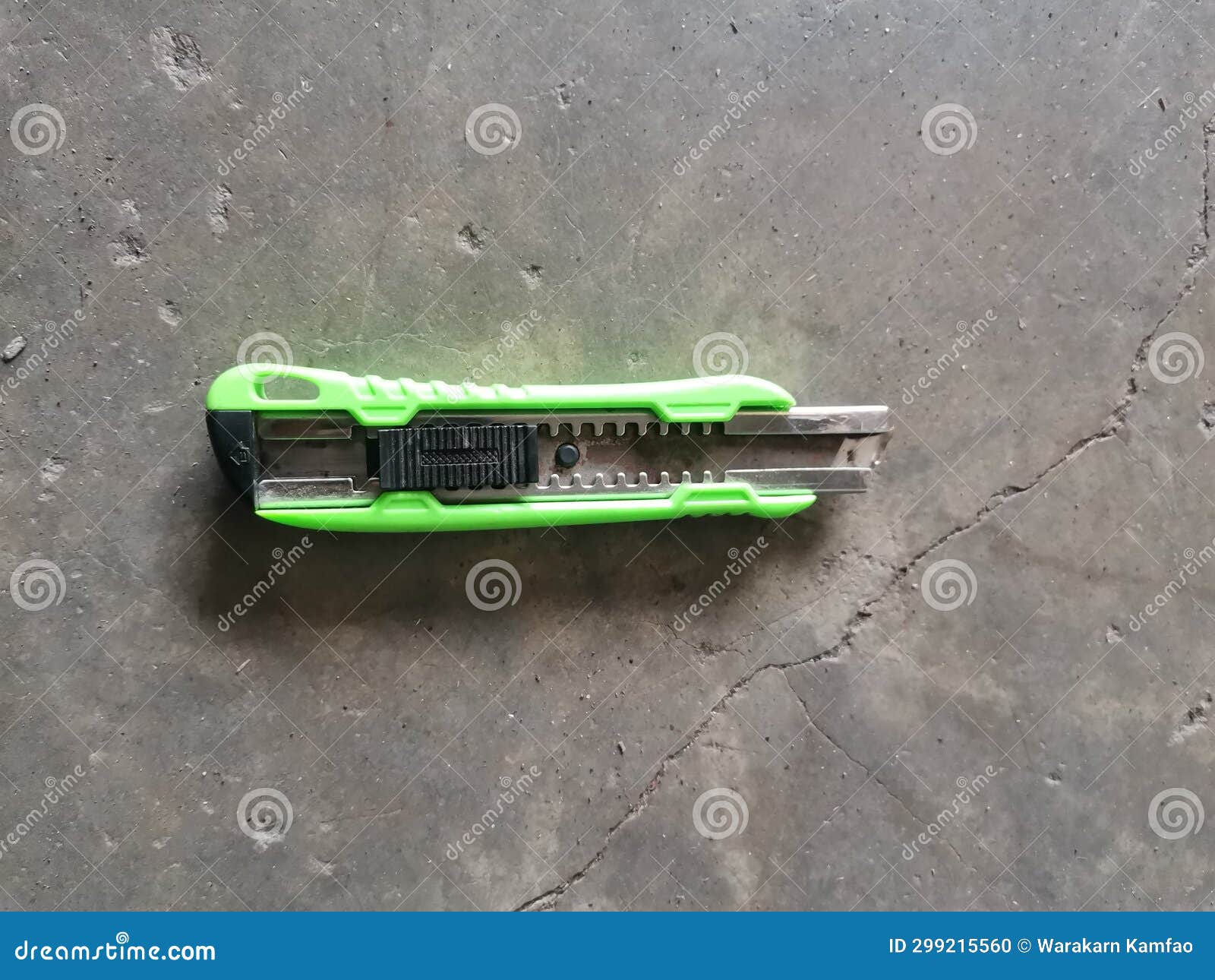 Green Paper Cutter on Cement Floor. Top View. Copy Space Stock Photo ...