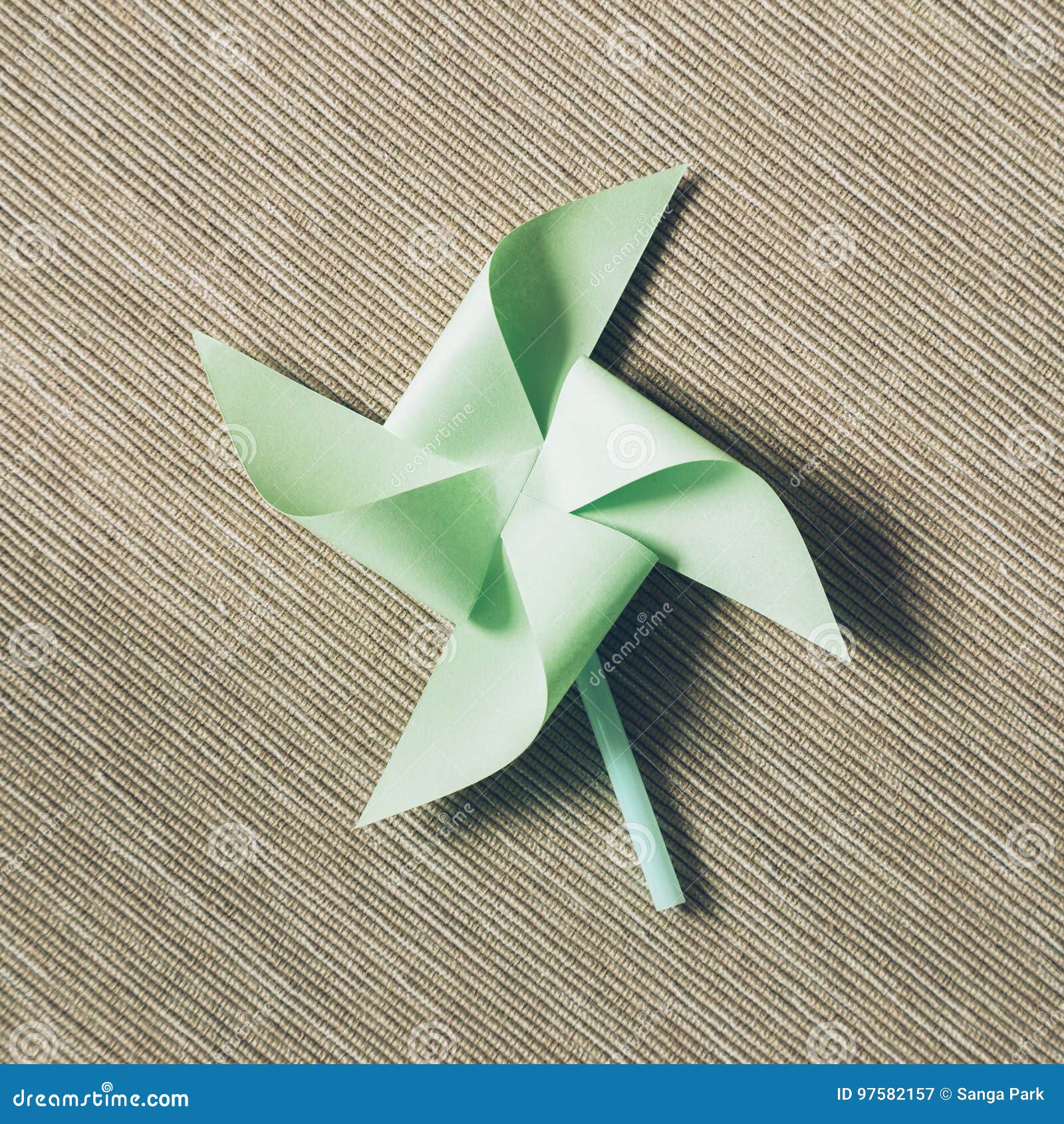 Green Paper Pinwheel on Brown Fabric Background Stock Image - Image of ...