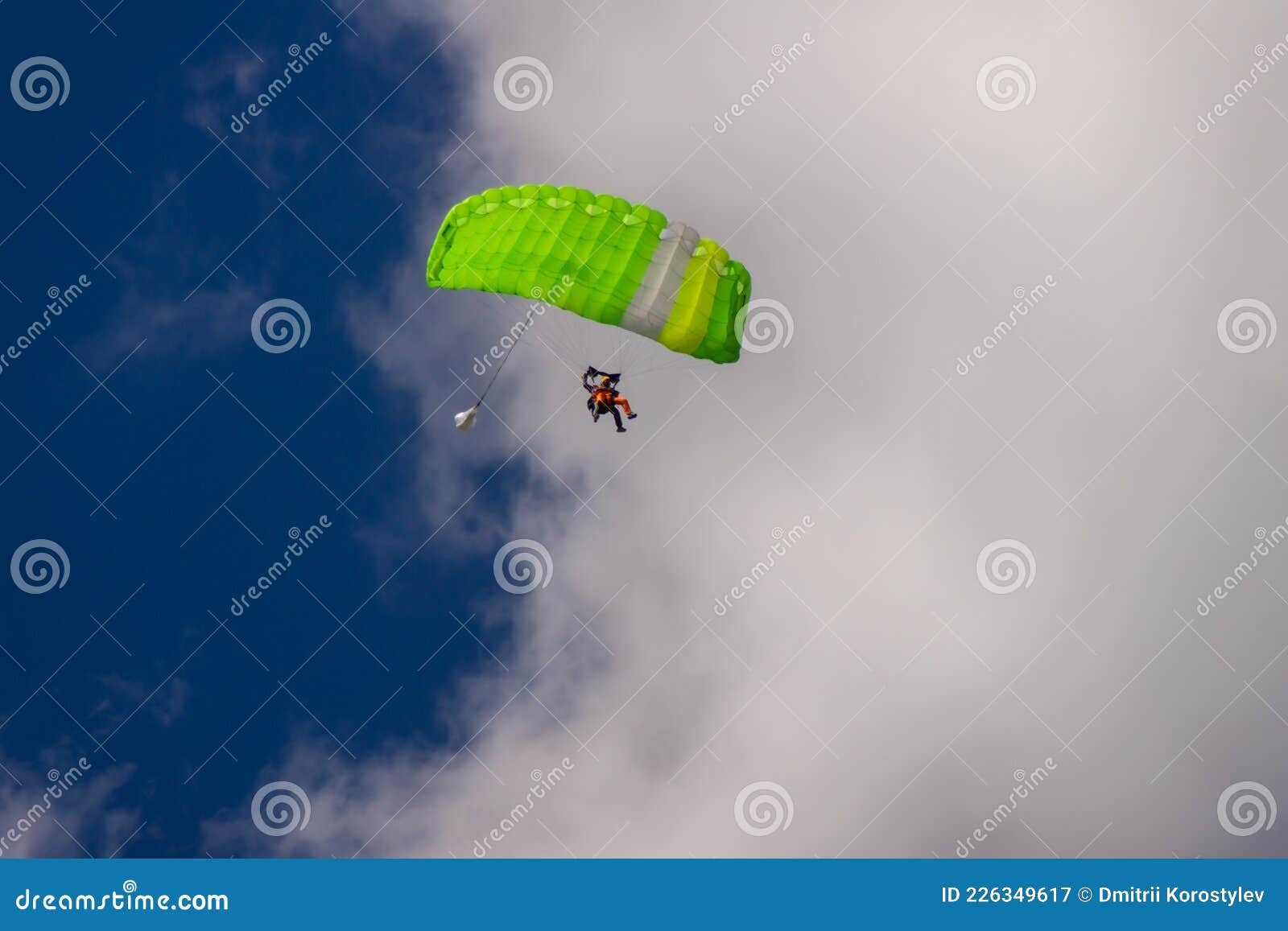 Green Parachute Against the Background of Blue Sky and Clouds Stock ...