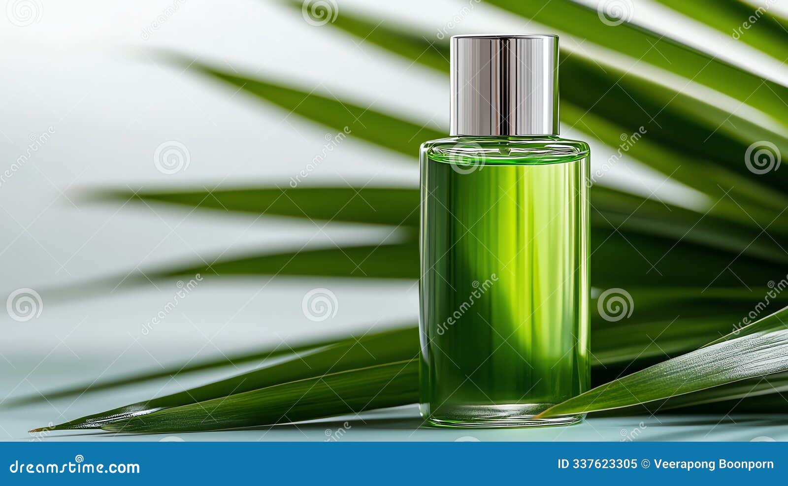 Green Perfume Bottle with Metallic Cap on Palm Leaves, Soft Focus ...