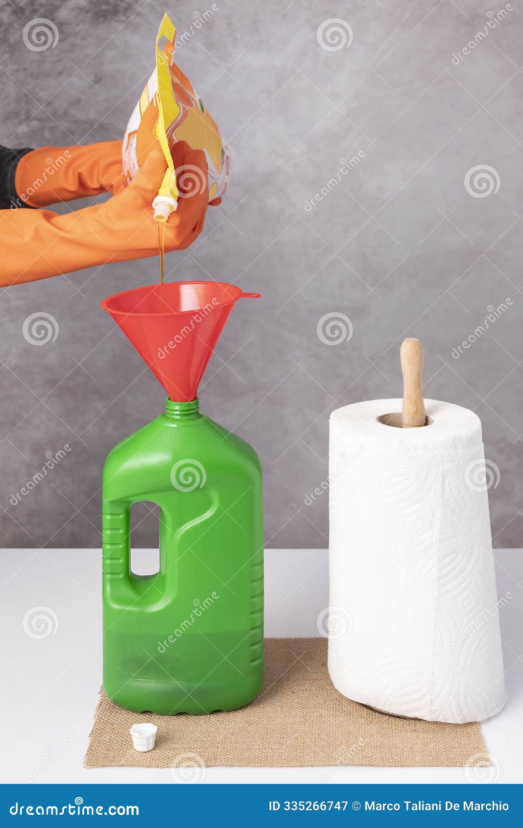 A Green Plastic Bottle is Filled with Dishwashing Liquid from a Refill ...